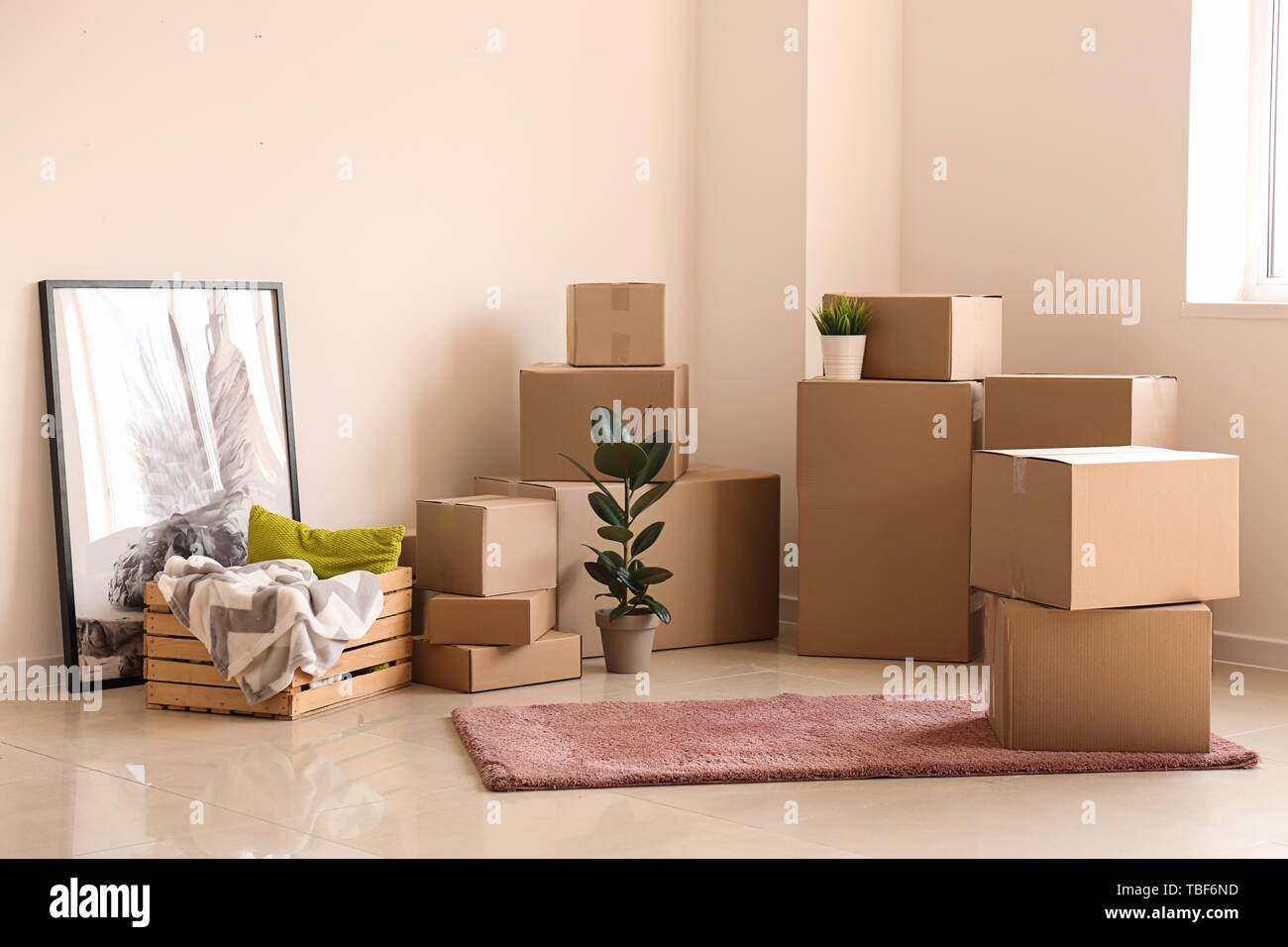Moving boxes with belongings in empty room Stock Photo - Alamy