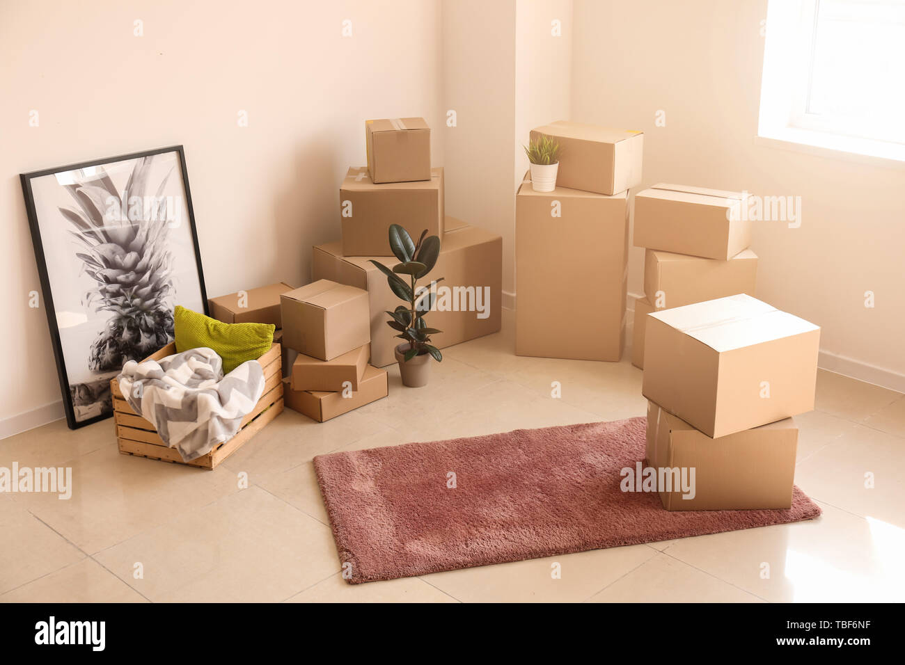 Moving boxes with belongings in empty room Stock Photo - Alamy