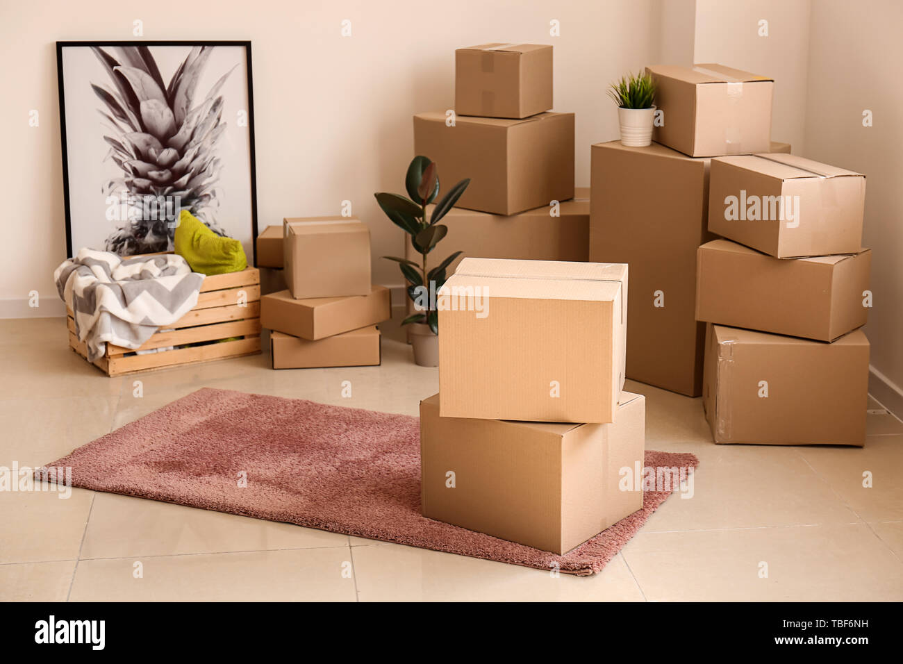 Moving boxes with belongings in empty room Stock Photo - Alamy