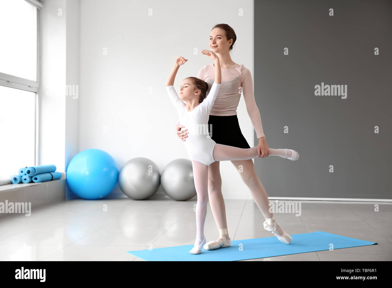 Little ballerina training with coach in dance studio Stock Photo - Alamy