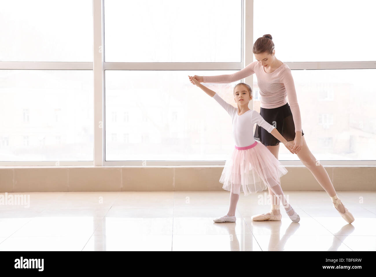 Little ballerina training with coach in dance studio Stock Photo - Alamy
