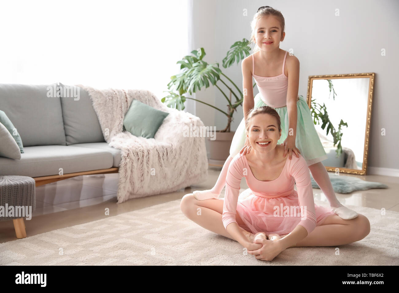 Little ballerina training with coach at home Stock Photo - Alamy