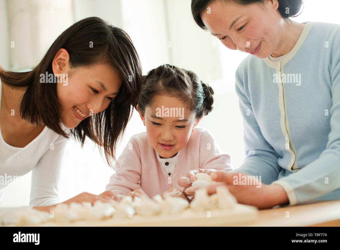 Mother and daughter making dumplings hi-res stock photography and ...