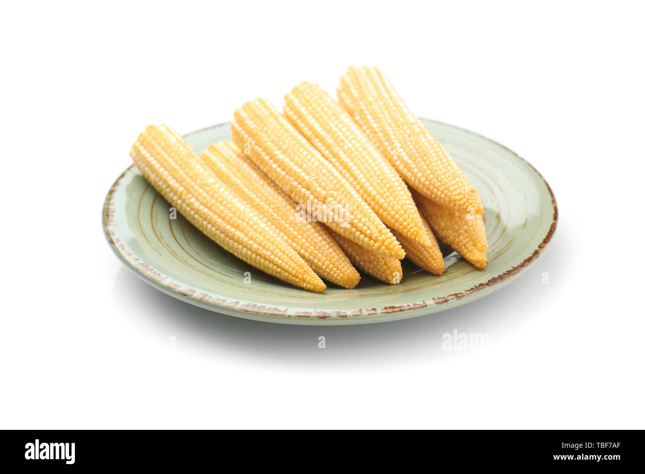 Plate with baby corn cobs on white background Stock Photo - Alamy