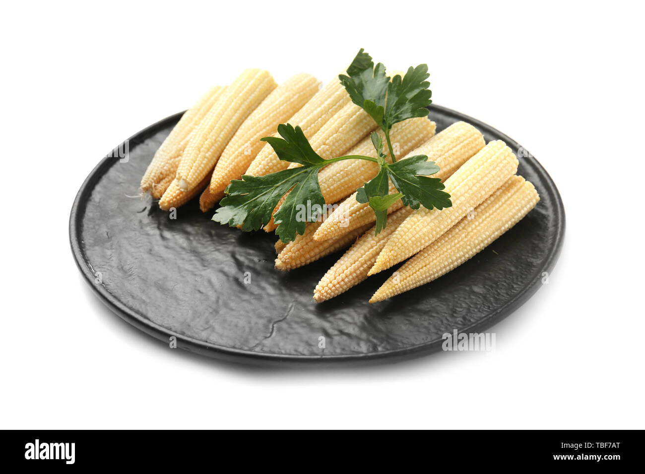Plate with baby corn cobs on white background Stock Photo - Alamy
