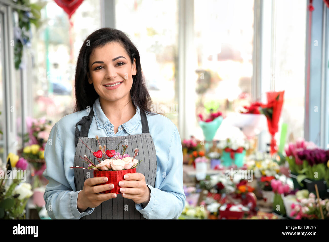 Beautiful female owner in flower shop Stock Photo - Alamy
