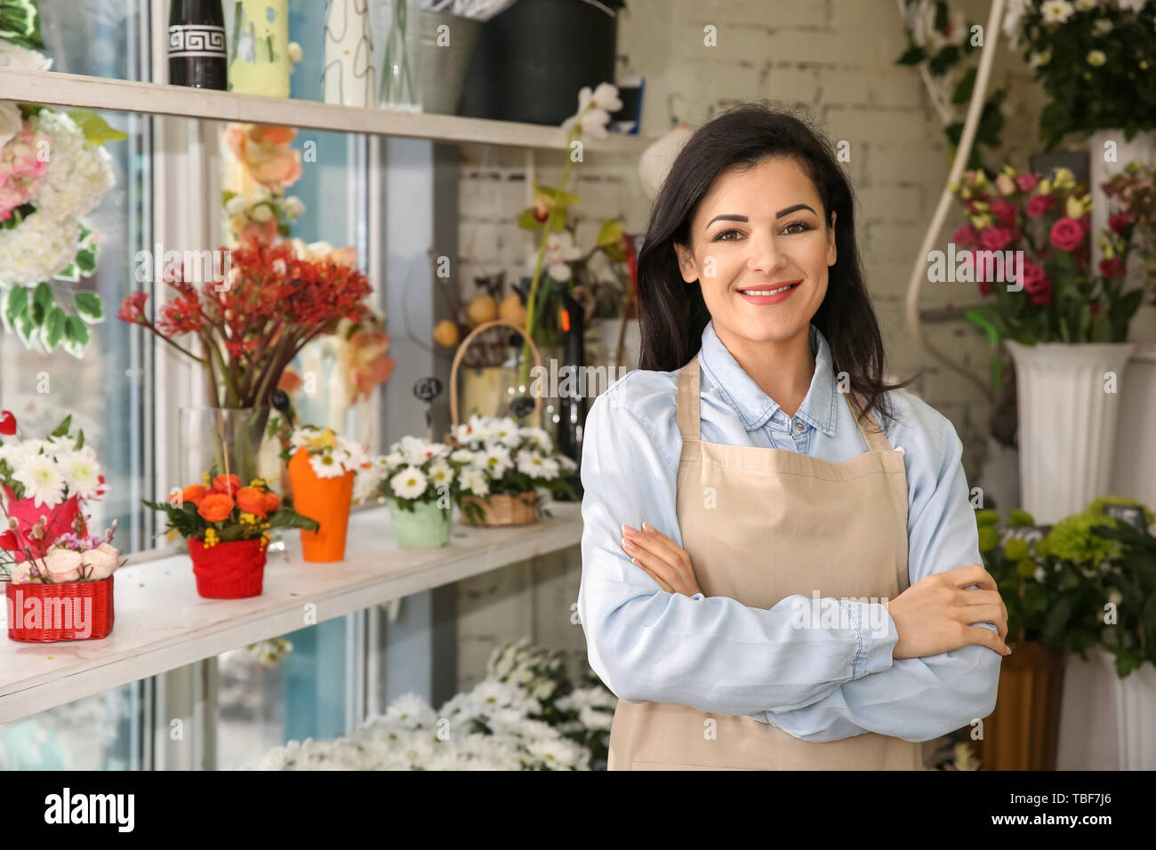 Beautiful female owner in flower shop Stock Photo - Alamy