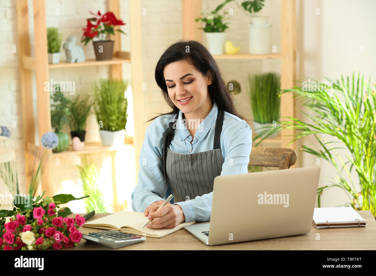 Beautiful female florist working hi-res stock photography and images ...