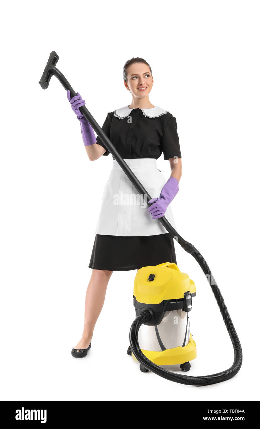 Portrait of beautiful female housekeeper with vacuum cleaner on white ...