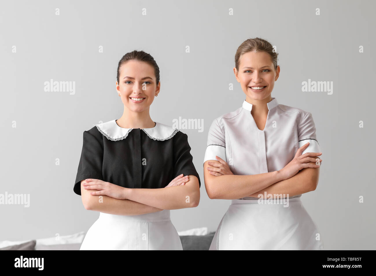 Portrait of beautiful female housekeepers in room Stock Photo - Alamy