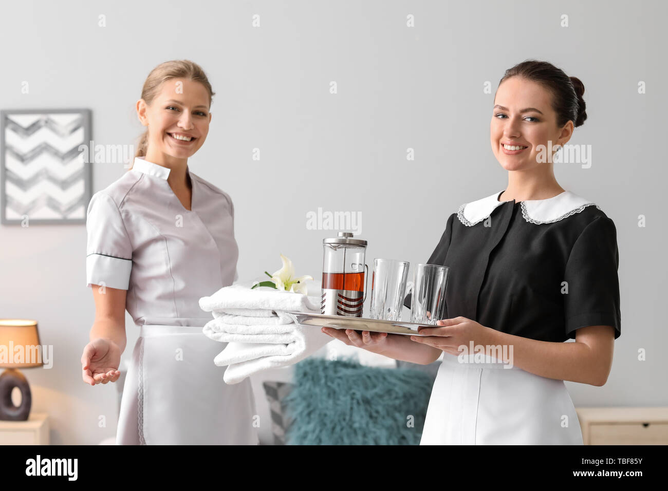 Portrait of beautiful female housekeepers in room Stock Photo - Alamy