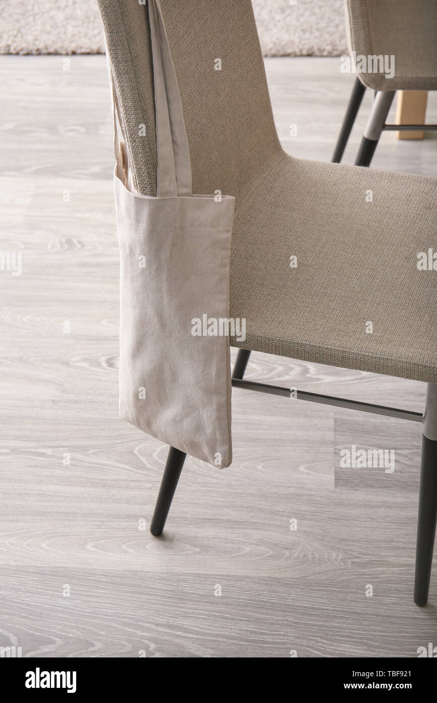 Eco bag hanging on back of chair in room Stock Photo - Alamy