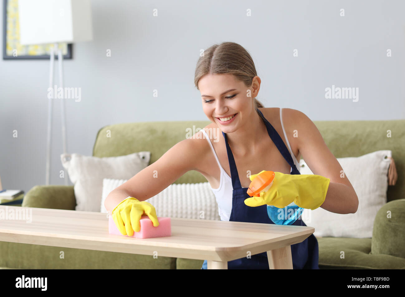 Beautiful woman cleaning table at home Stock Photo - Alamy