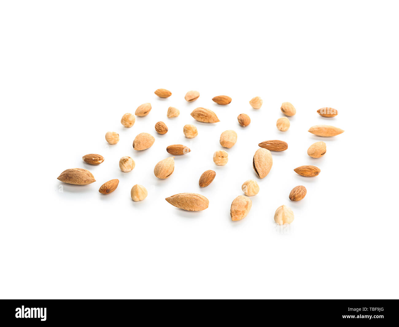 Different tasty nuts on white background Stock Photo - Alamy