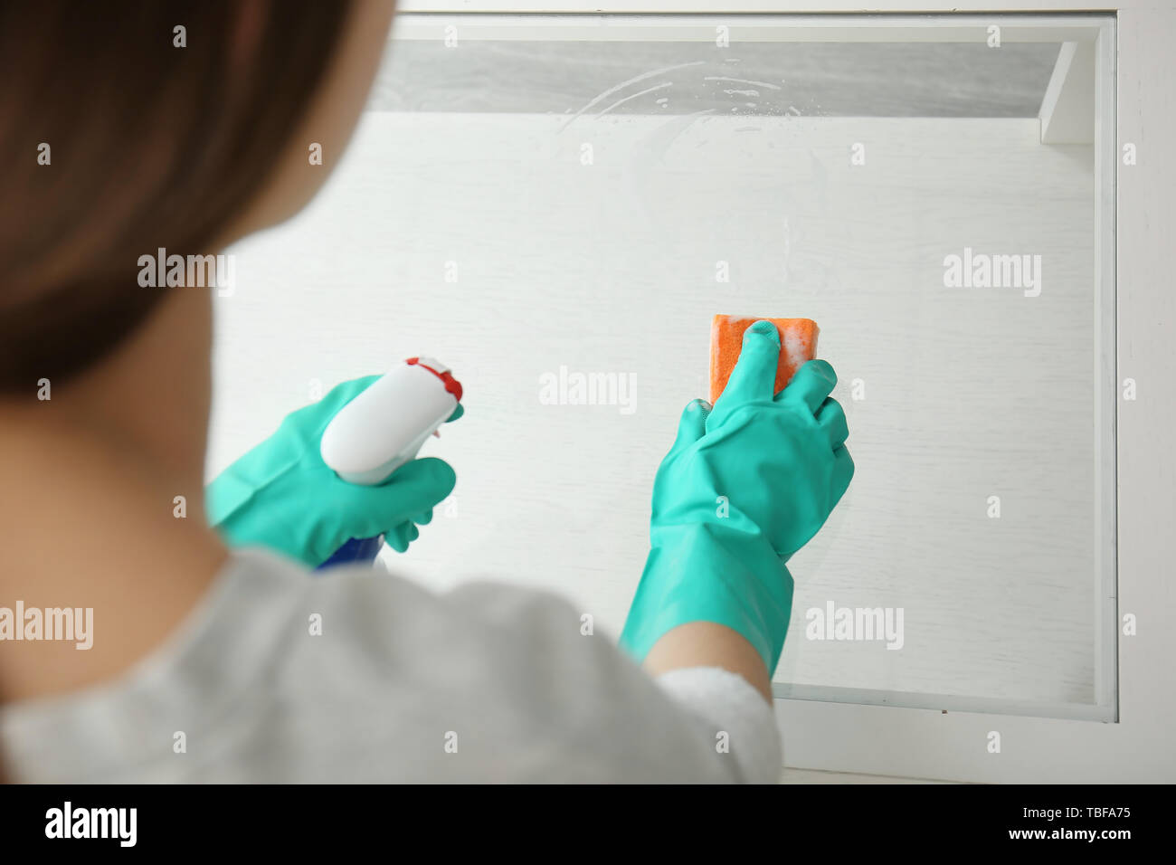 Woman cleaning glass table hi-res stock photography and images - Alamy