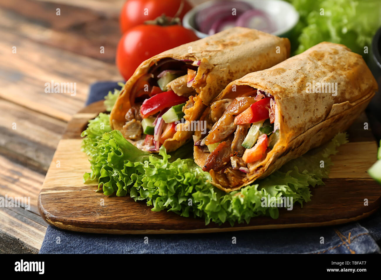 Board with tasty doner kebab on table Stock Photo - Alamy