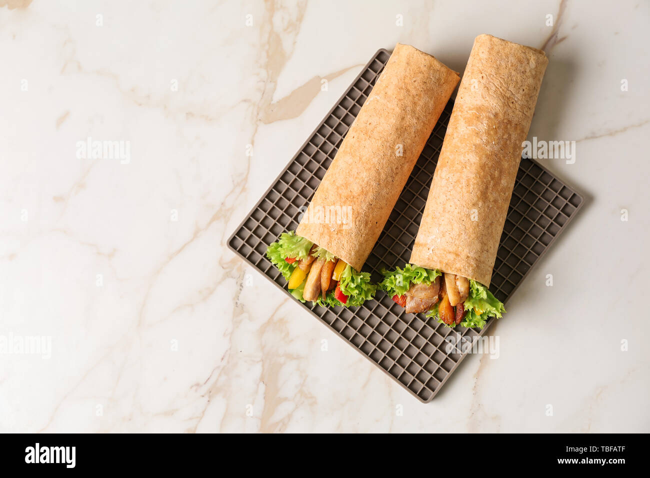 Board with tasty doner kebab on light background Stock Photo - Alamy