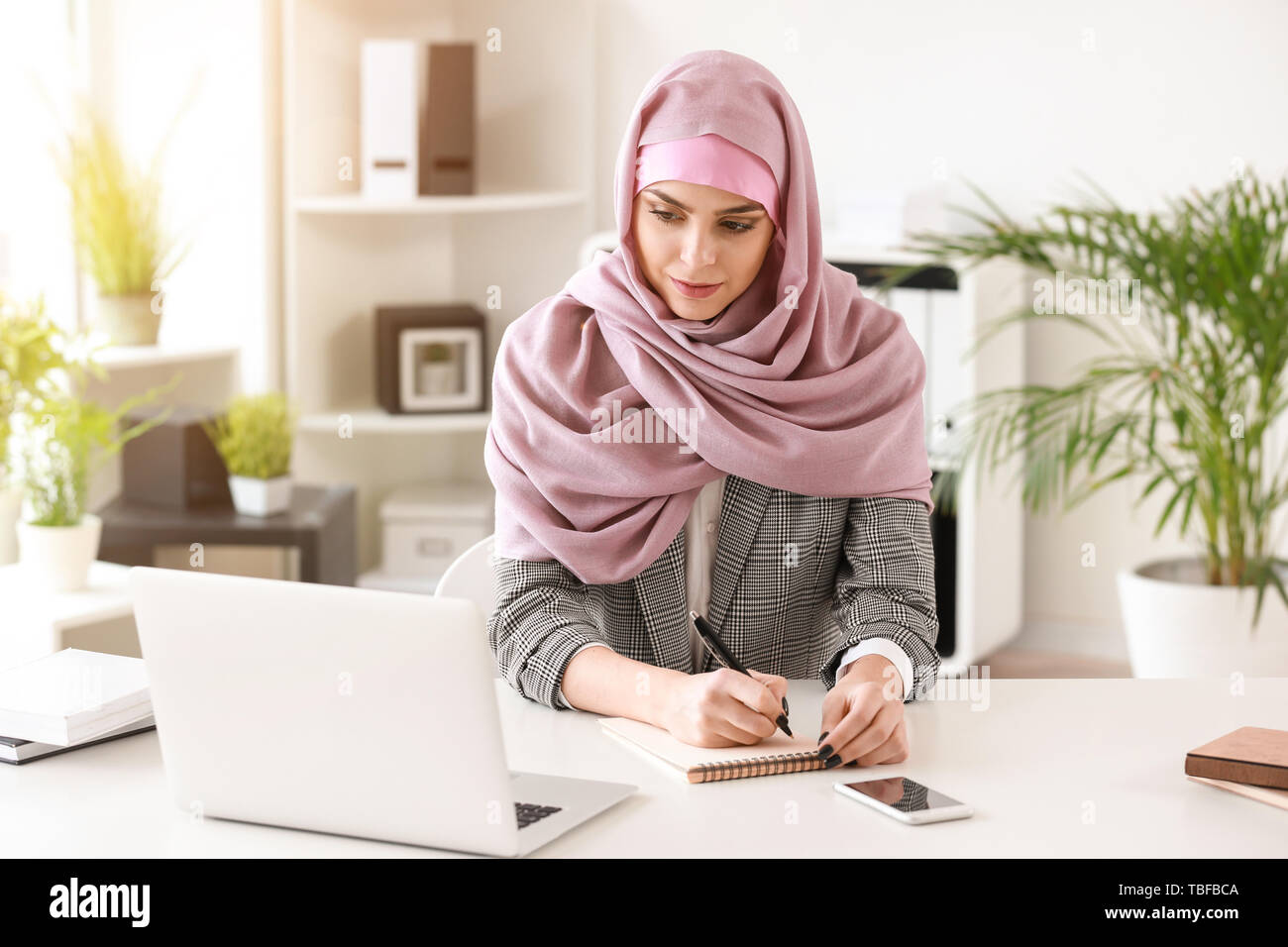 Female employee in hijab working in the office hi-res stock photography ...