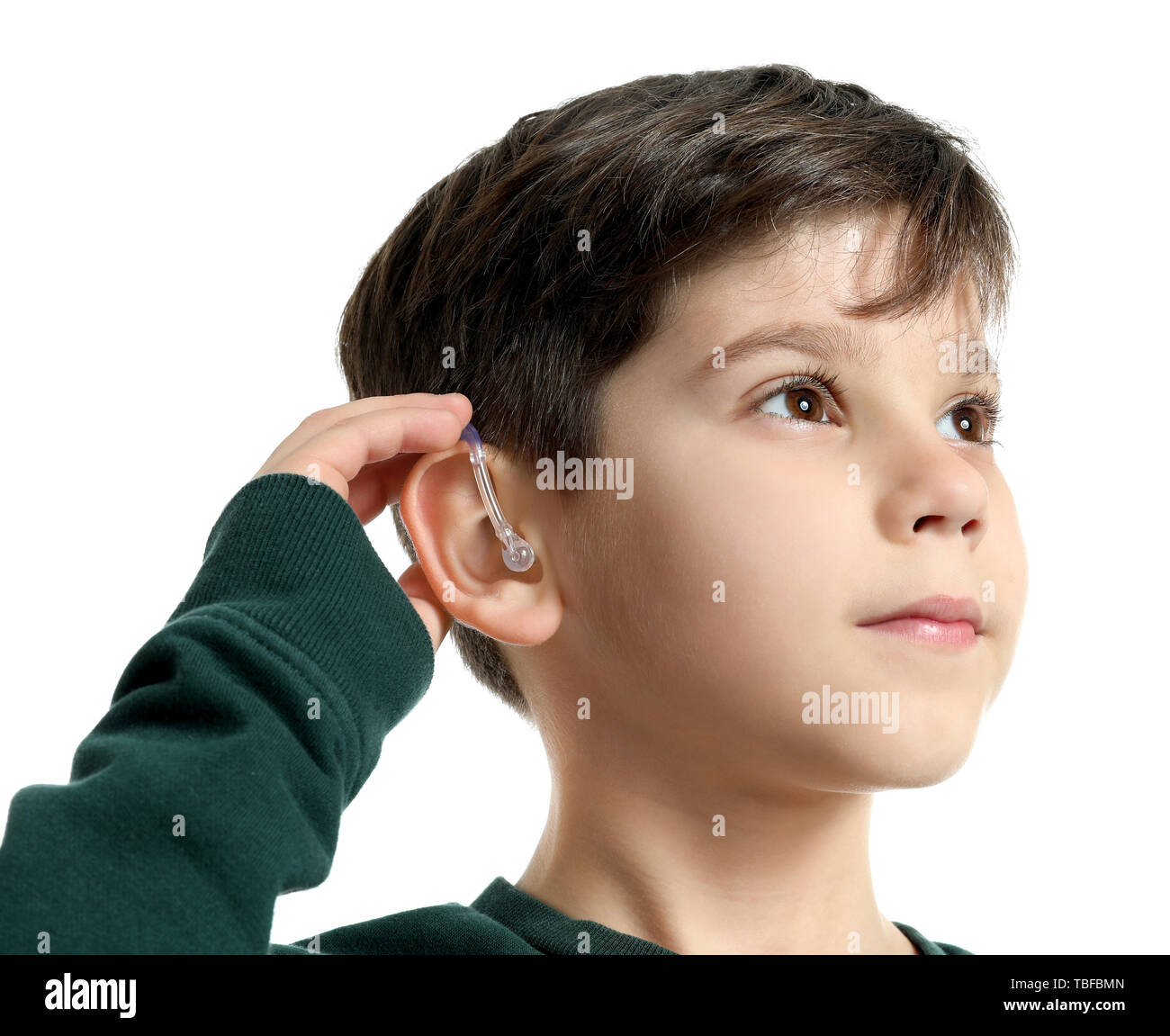 Little boy with hearing aid on white background Stock Photo - Alamy
