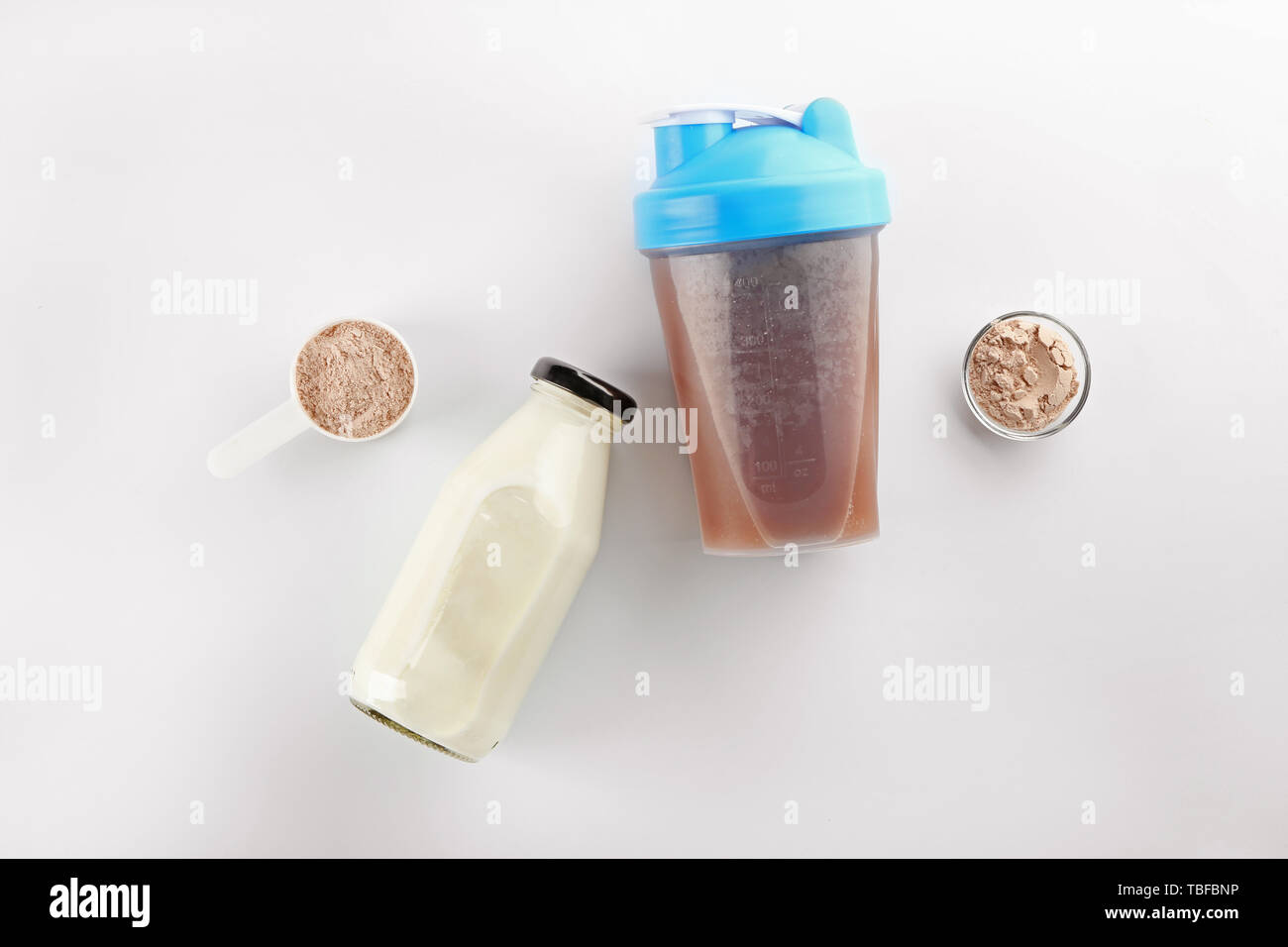Bottles of protein shake and milk on white background Stock Photo - Alamy