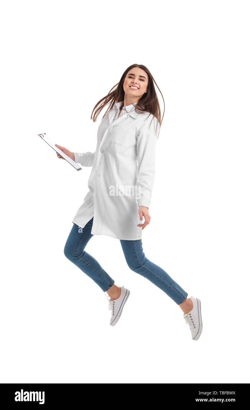 Happy female doctor jumping against white background Stock Photo - Alamy