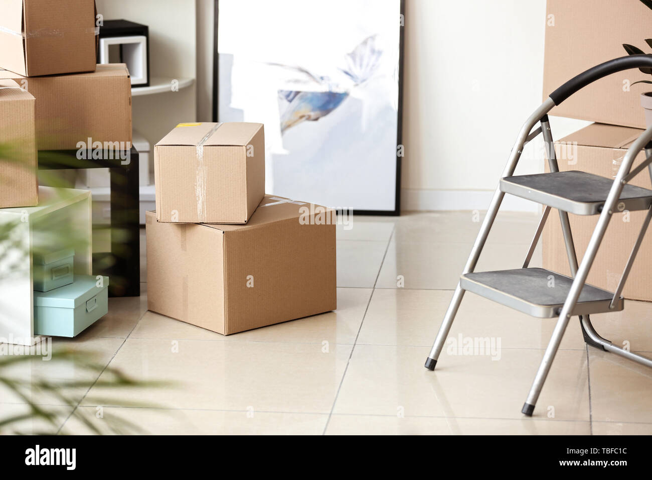 Belongings and moving boxes in room Stock Photo - Alamy