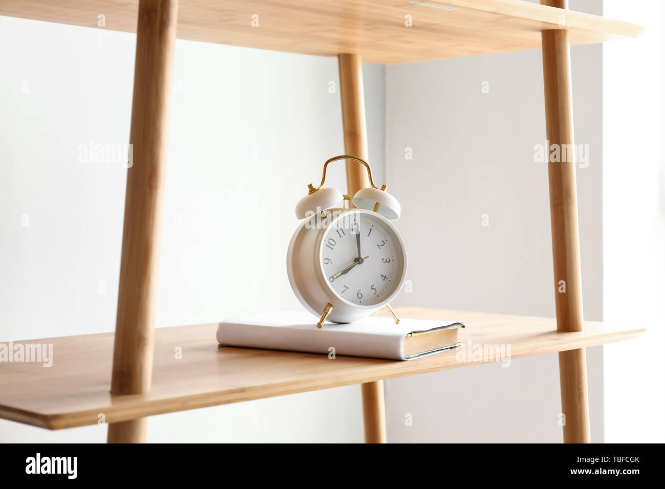 Book and clock on shelf in room Stock Photo - Alamy