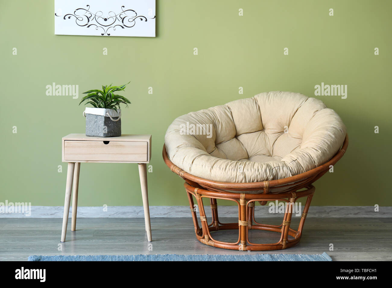 Interior of room with armchair and table Stock Photo - Alamy