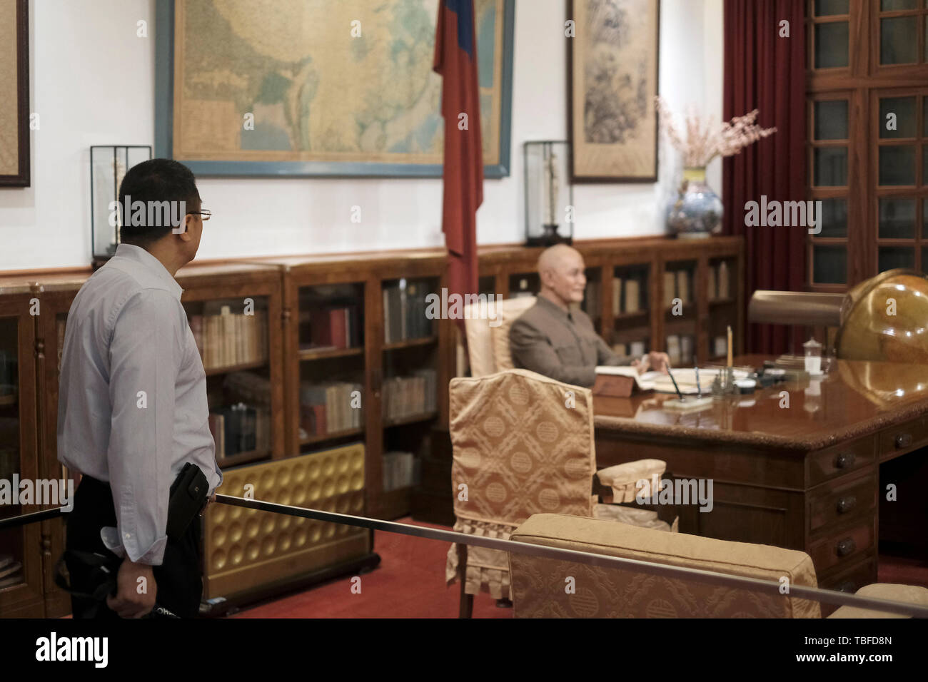 A visitor looks at a museum reproduction of Chiang Kai-shek study room ...