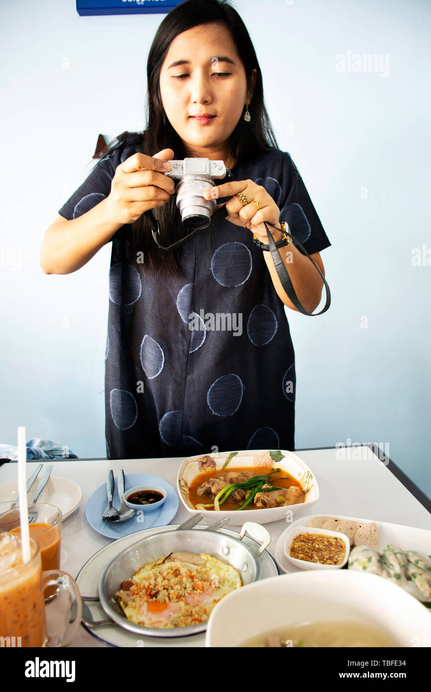 Travelers thai women posing for take photo with food set breakfast thai ...
