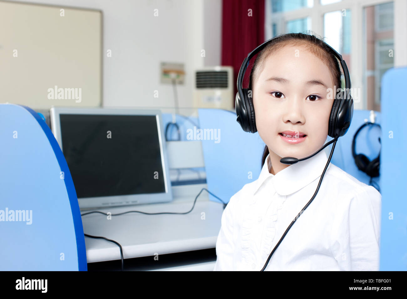 Three primary school students are in class in the classroom Stock Photo ...