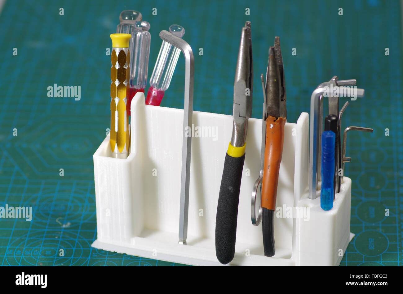 Numerous handmade tools on a white 3D printed tool stand Stock Photo ...