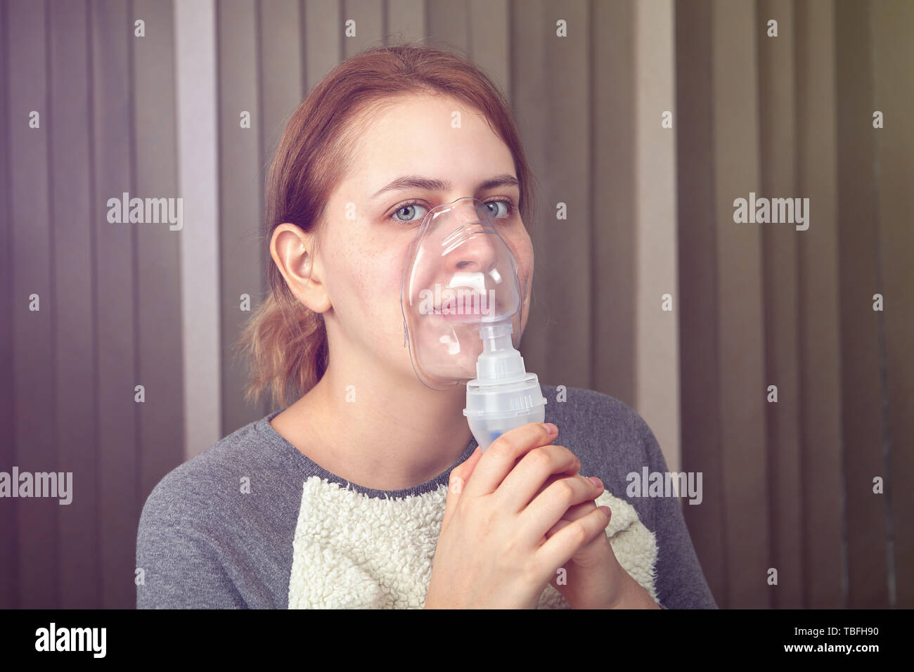 Woman, who has chronic obstructive pulmonary disease, is breathing with ...