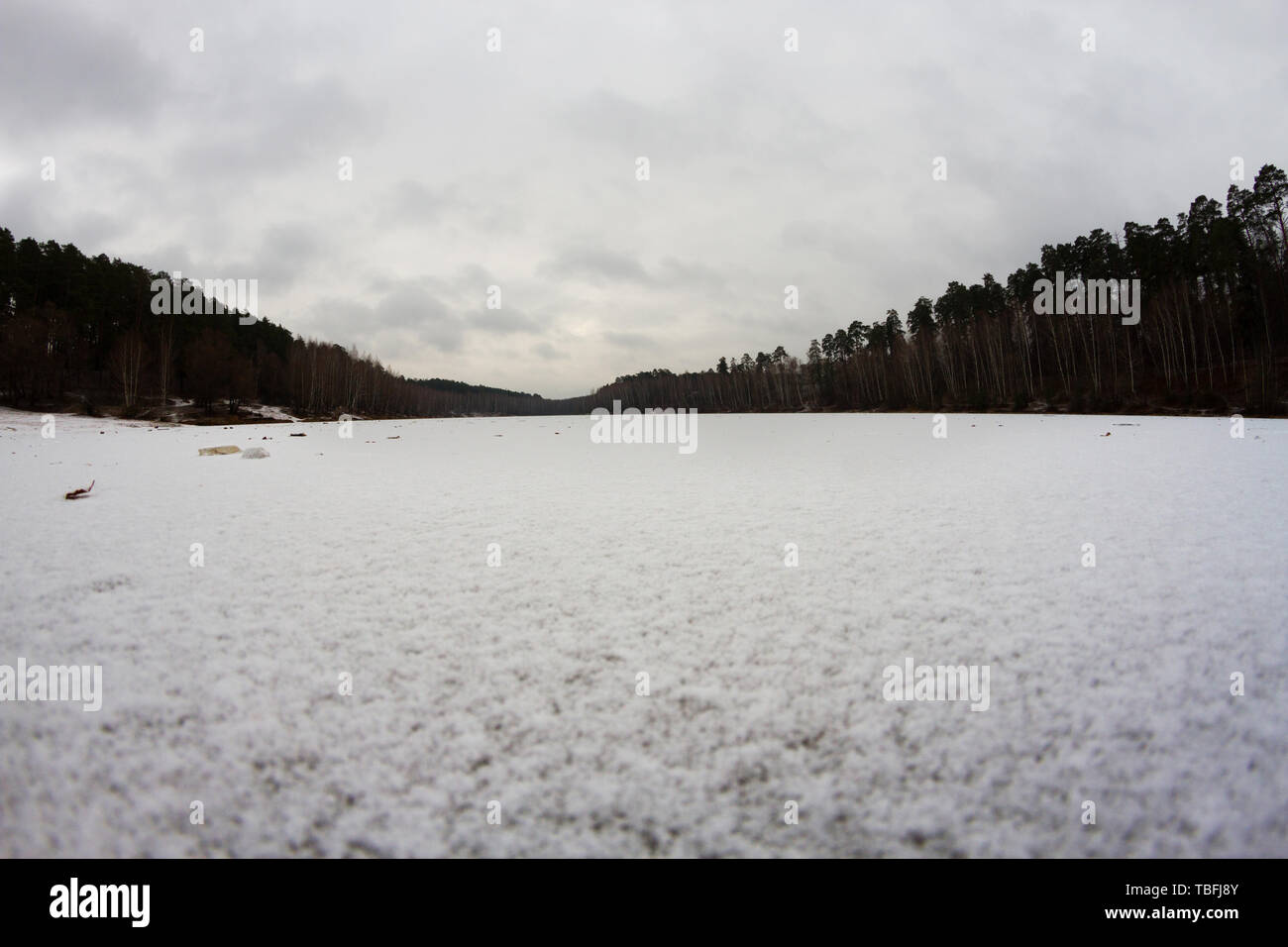 moody landscape with winter frozen lake. grey color Stock Photo - Alamy