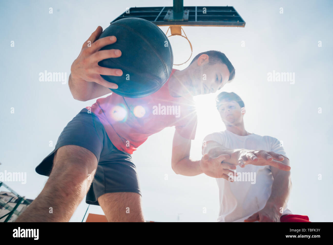 Close up portrait of two basketball players while the push each other ...