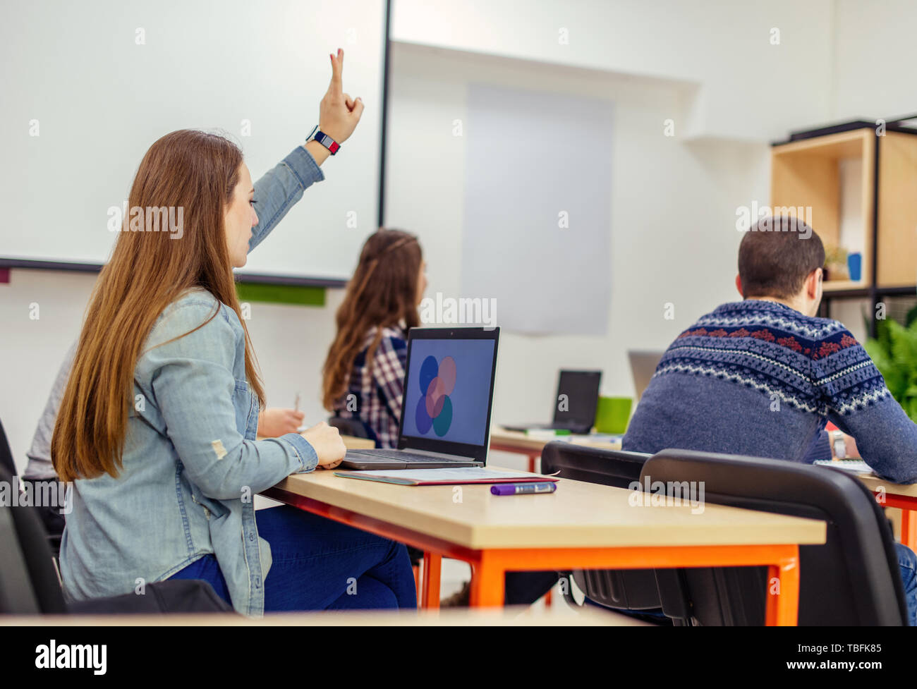 Modern students are sitting in classroom and looking interested Stock ...