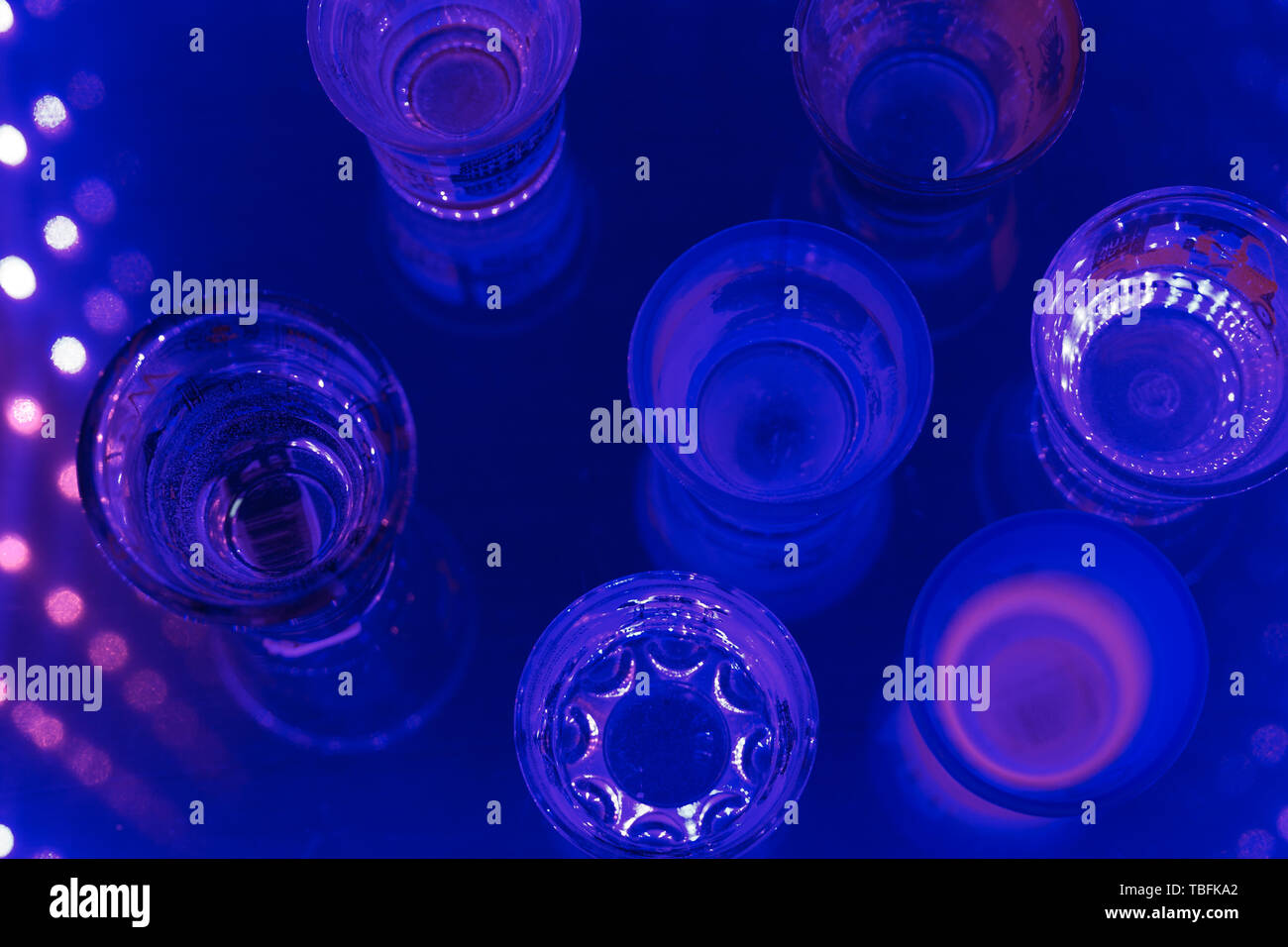 shots with alcohol in blue neon light Stock Photo - Alamy