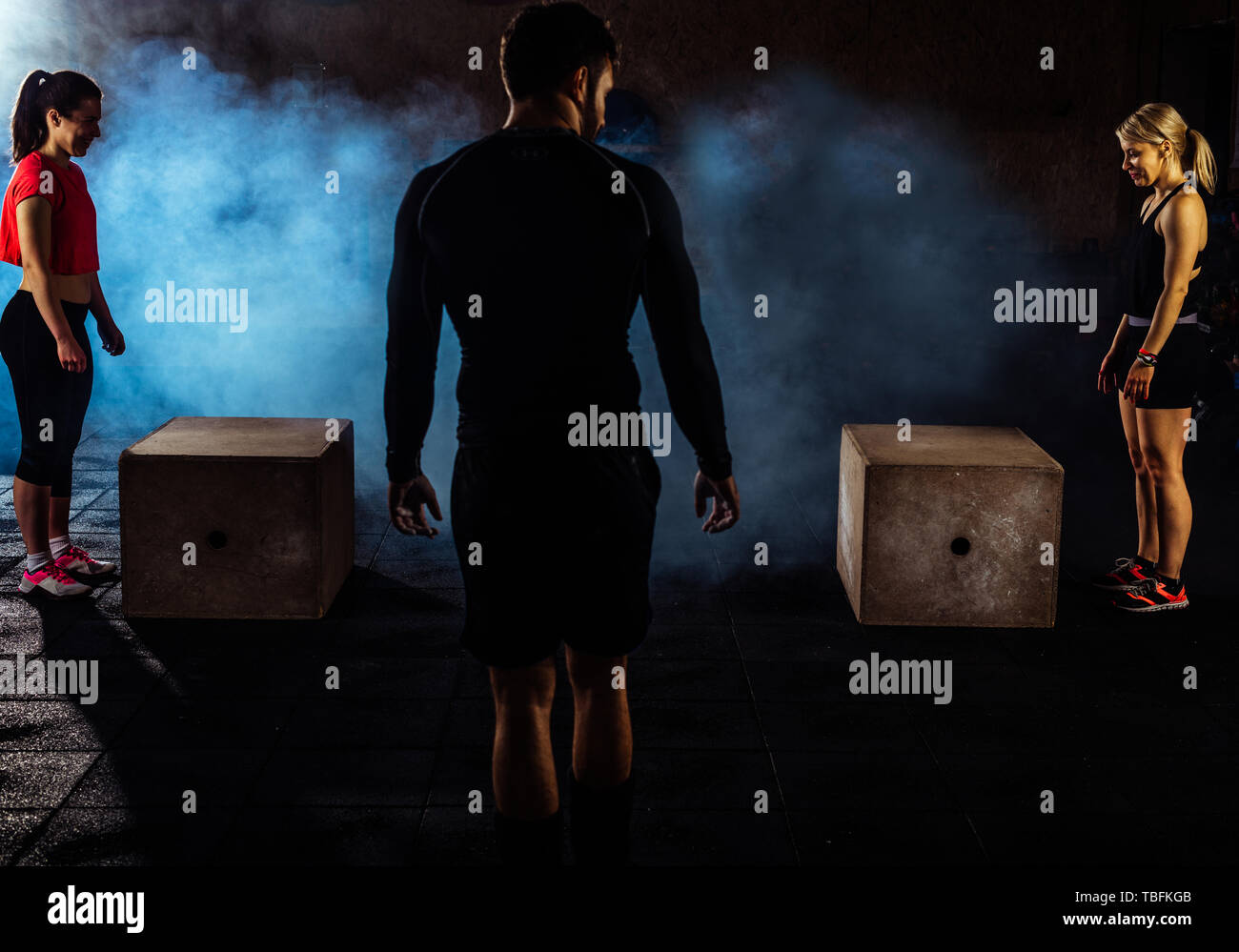 Athletes practicing box jumps in crossfit center Stock Photo - Alamy