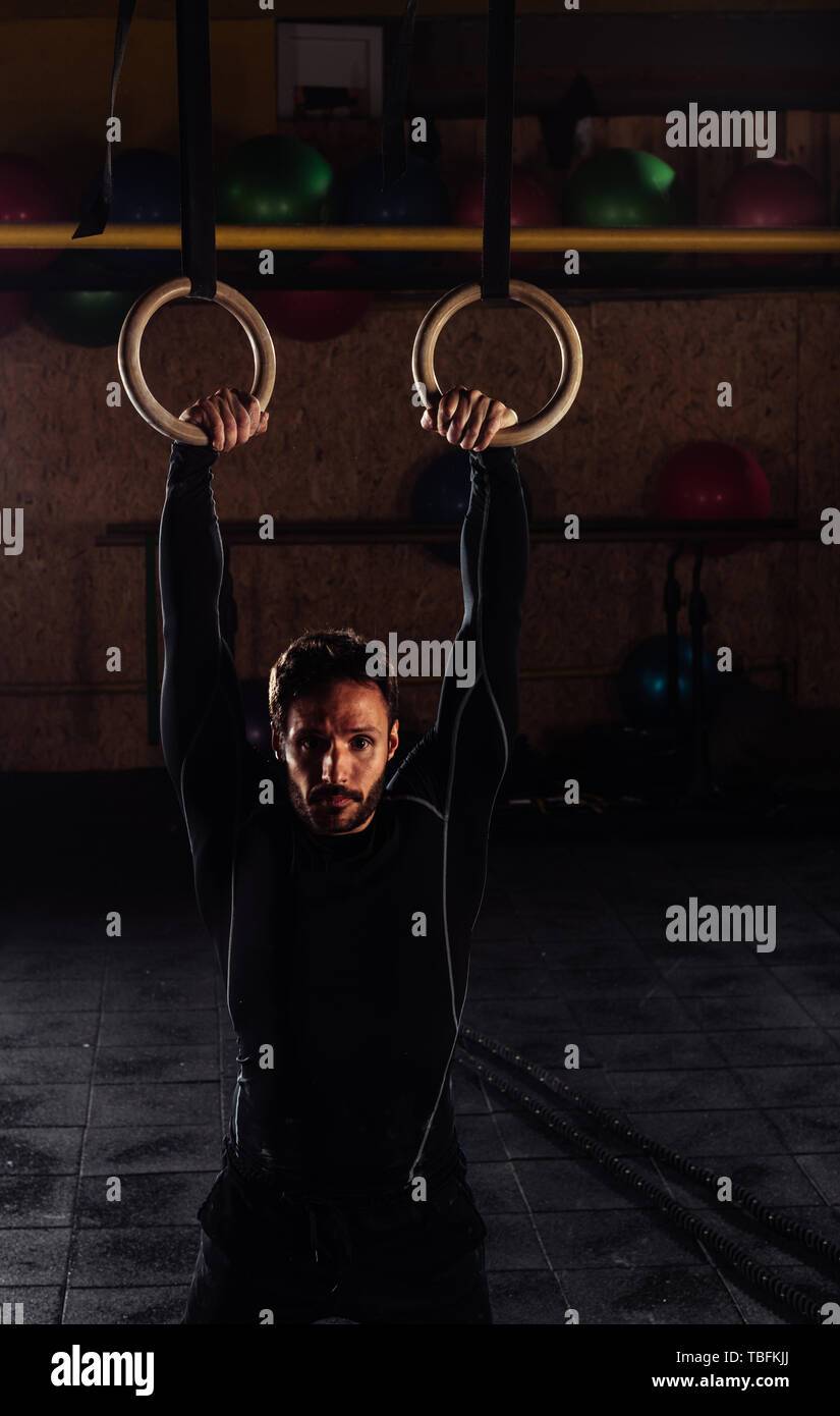 Fitness trainer doing dipping exercise using rings in the gym Stock ...