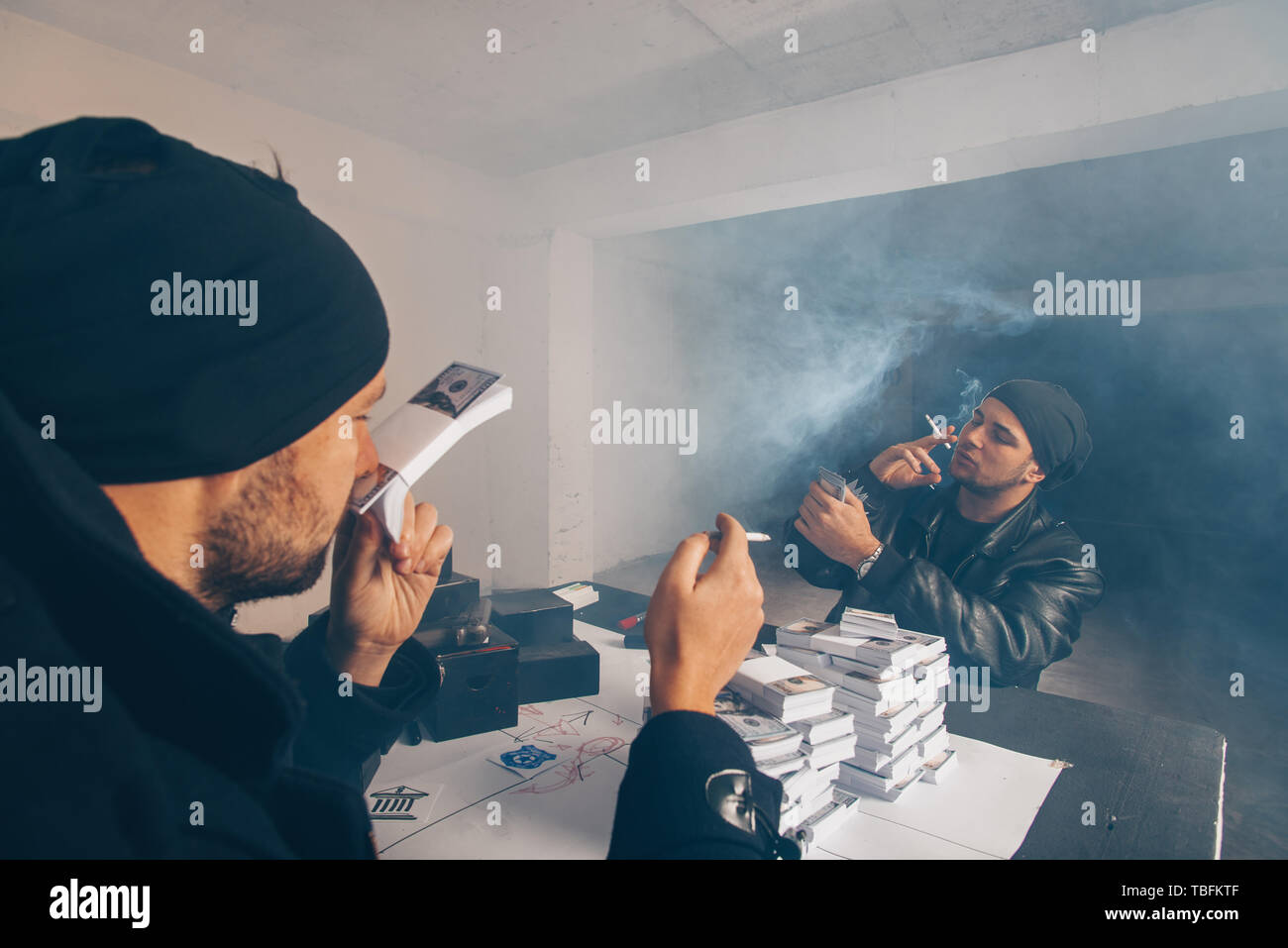 Criminals sitting in isolated room and counting money after heist Stock ...