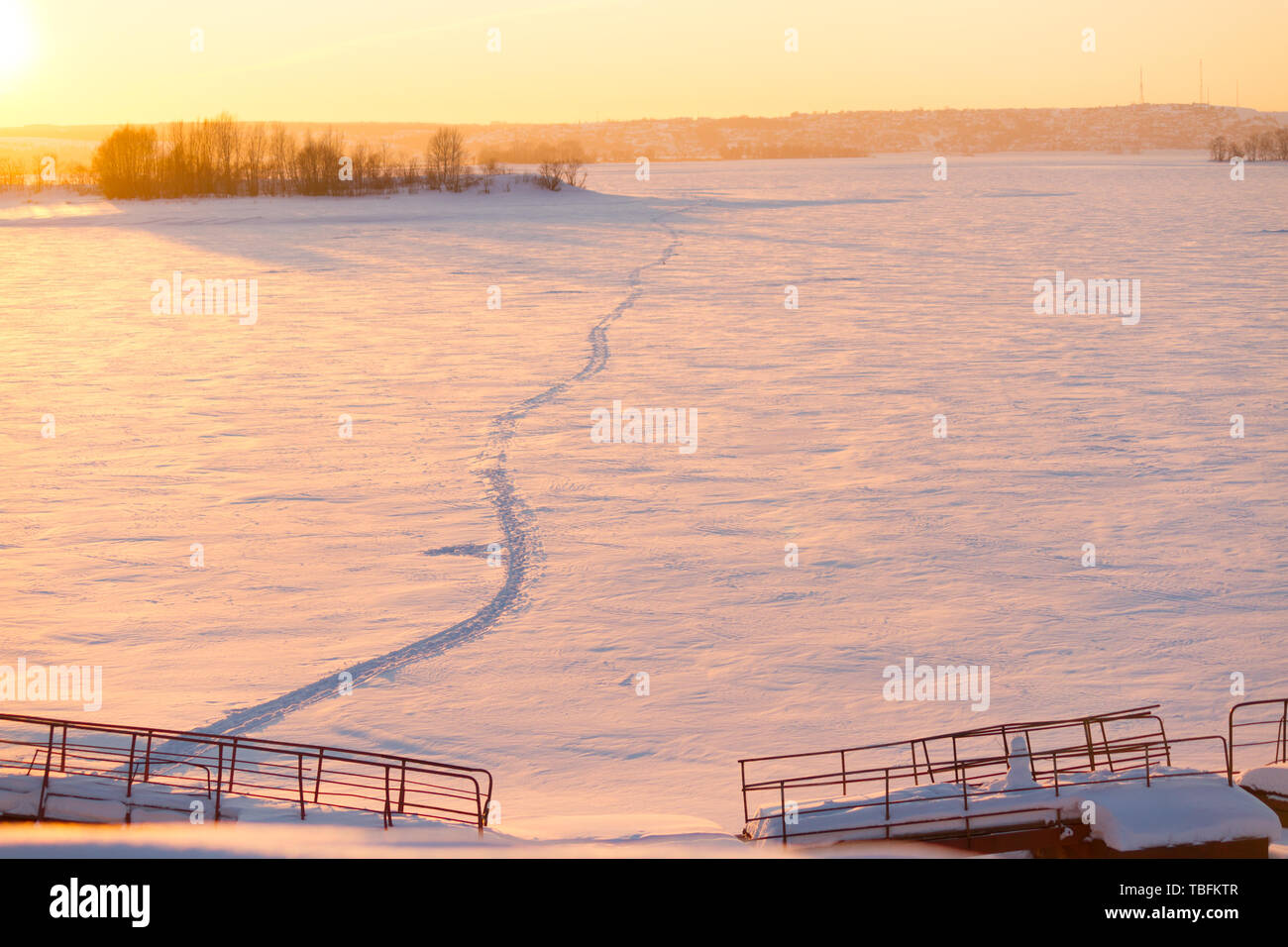 winter sunset over field. foot path Stock Photo - Alamy