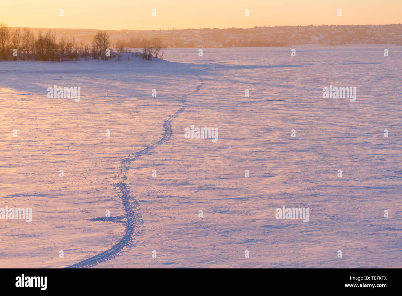 winter sunset over field. foot path Stock Photo - Alamy