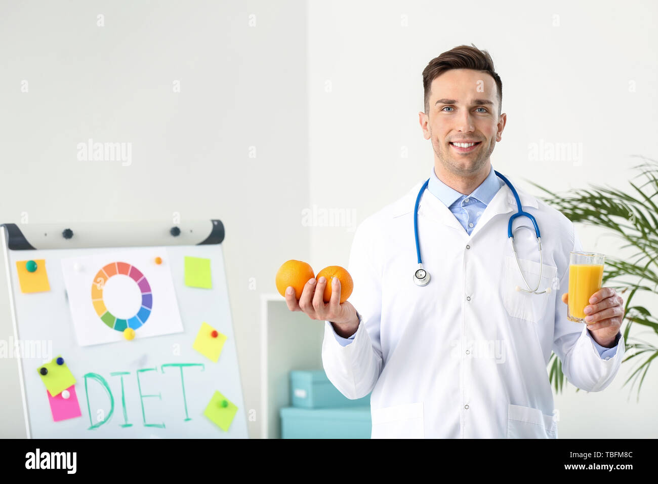 Portrait of male nutritionist in his office Stock Photo - Alamy