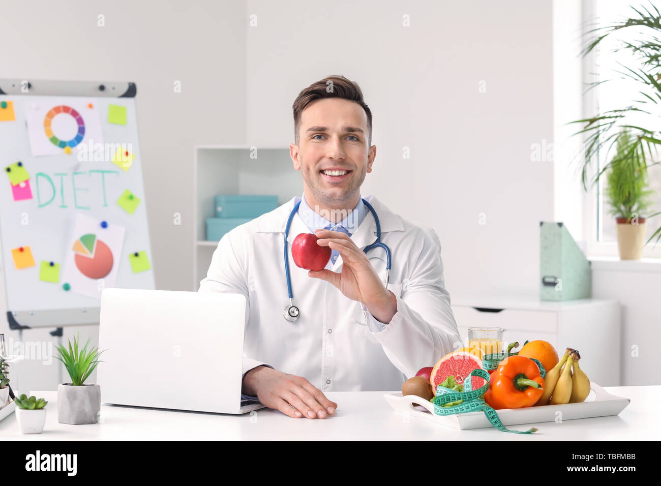 Portrait of male nutritionist in his office Stock Photo - Alamy