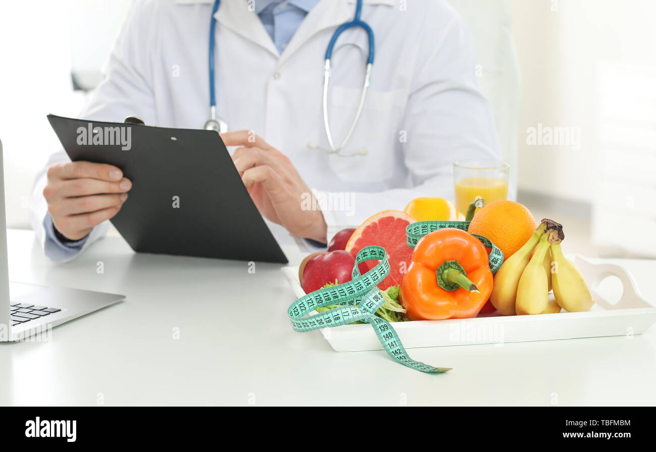 Male nutritionist working in his office Stock Photo - Alamy