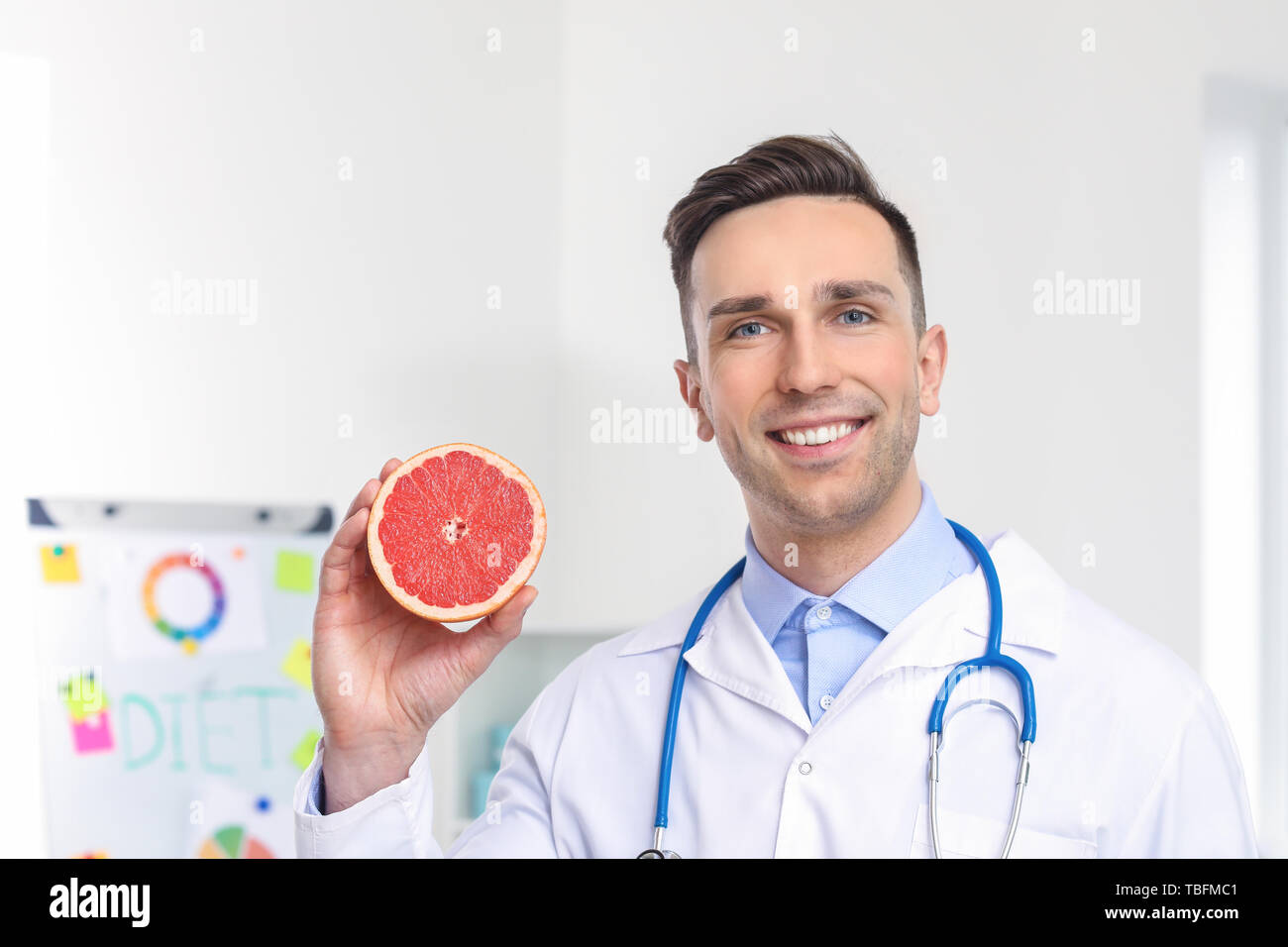 Portrait of male nutritionist in his office Stock Photo - Alamy