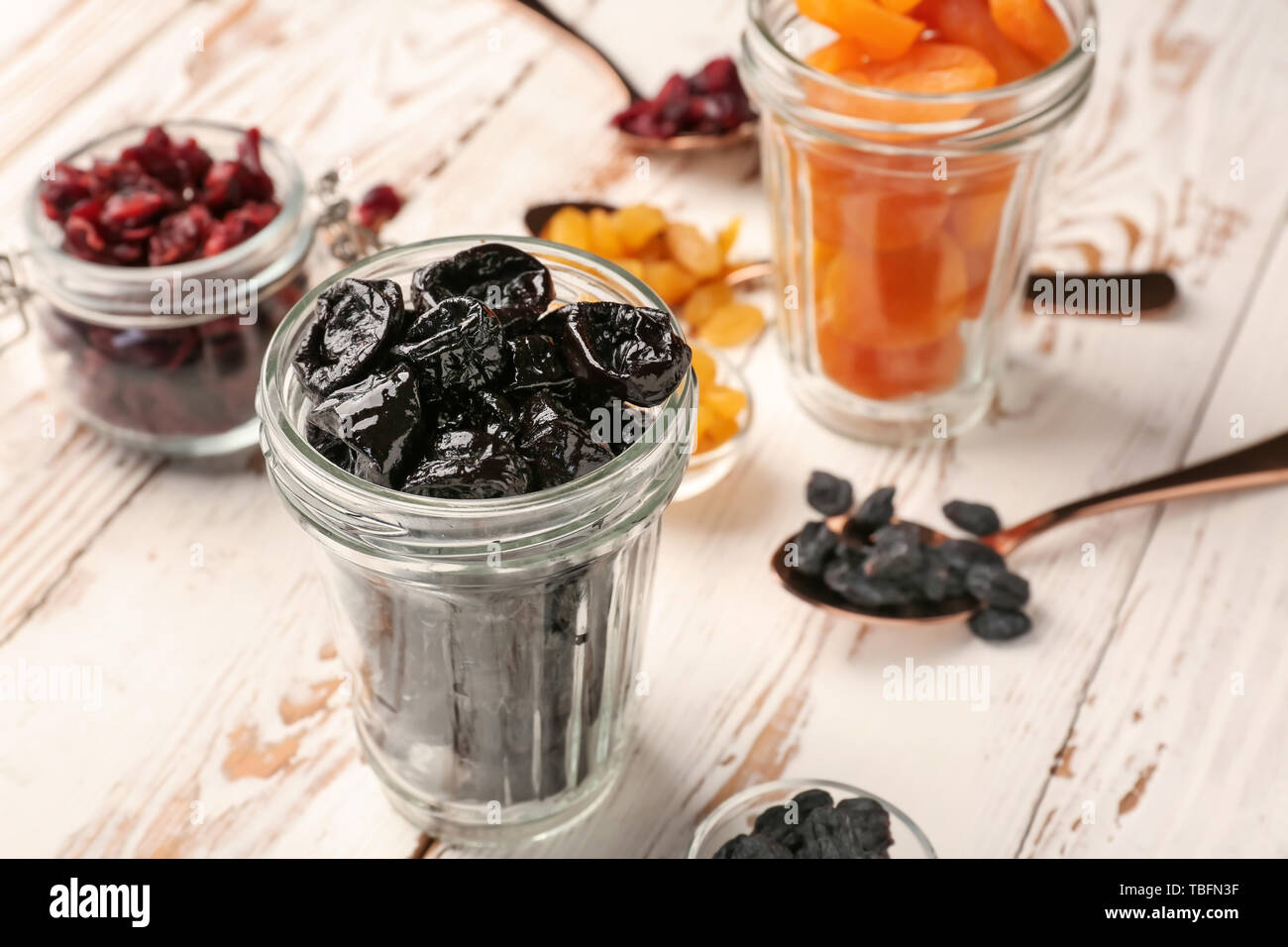 Jar of tasty prunes on white table Stock Photo - Alamy