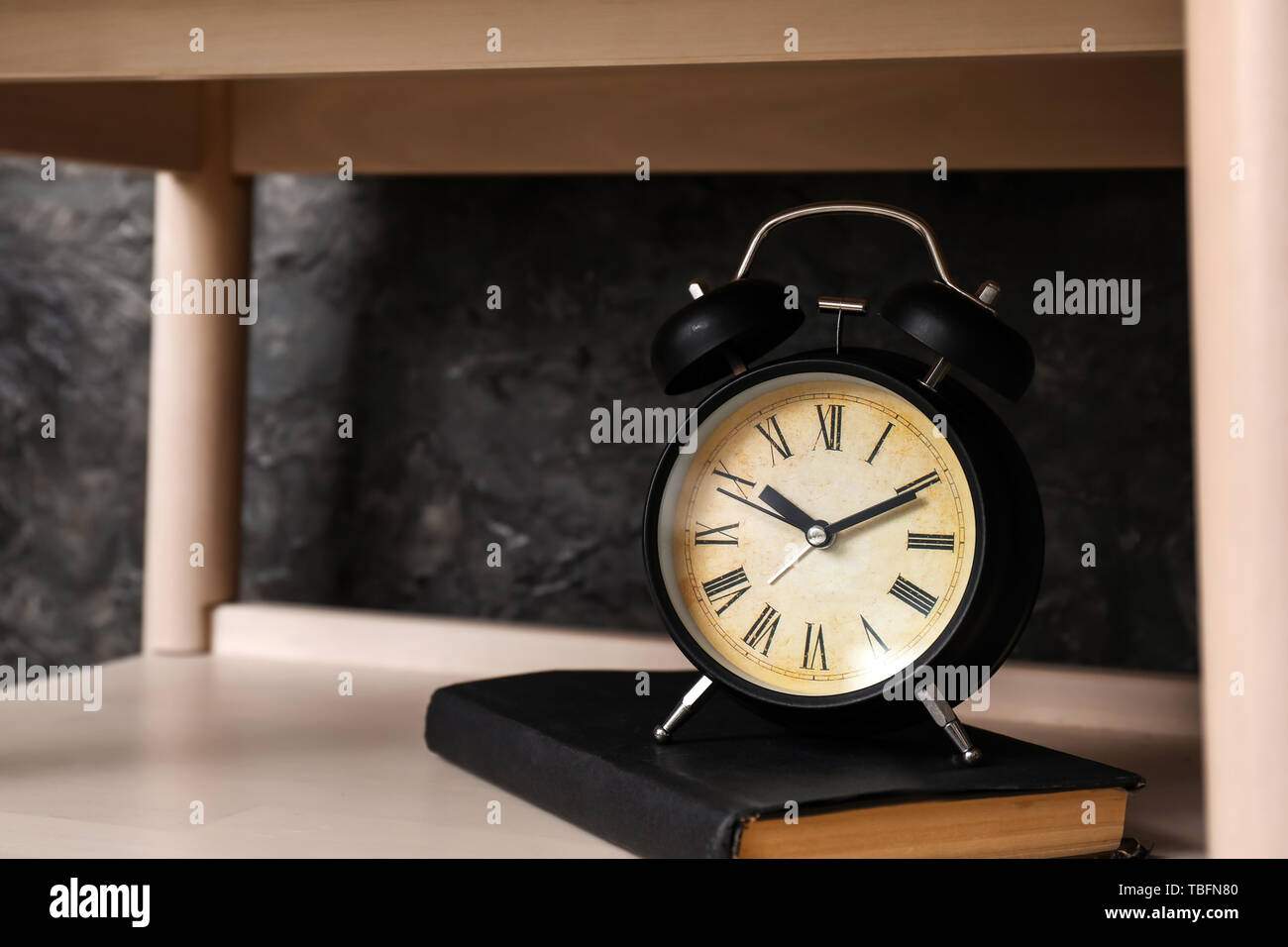 Book and clock on shelf in room Stock Photo - Alamy