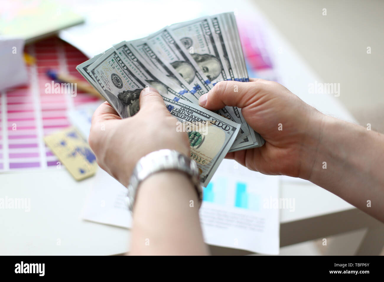 Male hands counting money from huge pack Stock Photo - Alamy