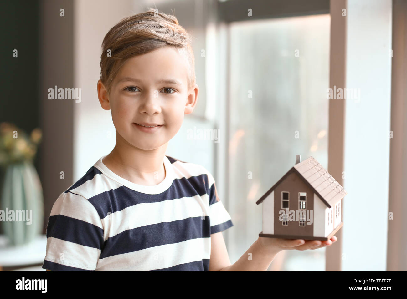 Little boy with model of house indoors. Concept of earthquake Stock ...